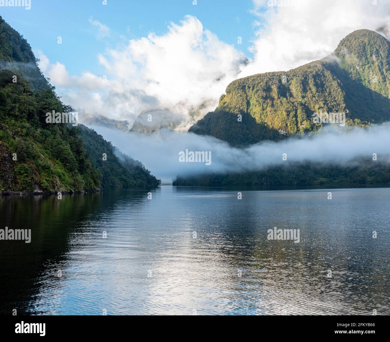 A new morning dawning at Doutful Sound, clouds hanging low in the ...