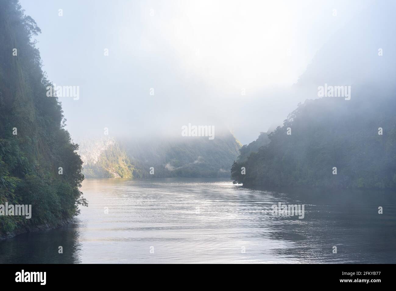 A new morning dawning at Doutful Sound, clouds hanging low in the ...