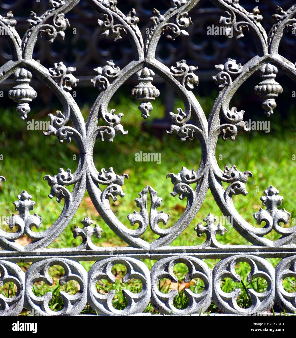 Background image of an old cemetery fence. Fence is metal with an ...