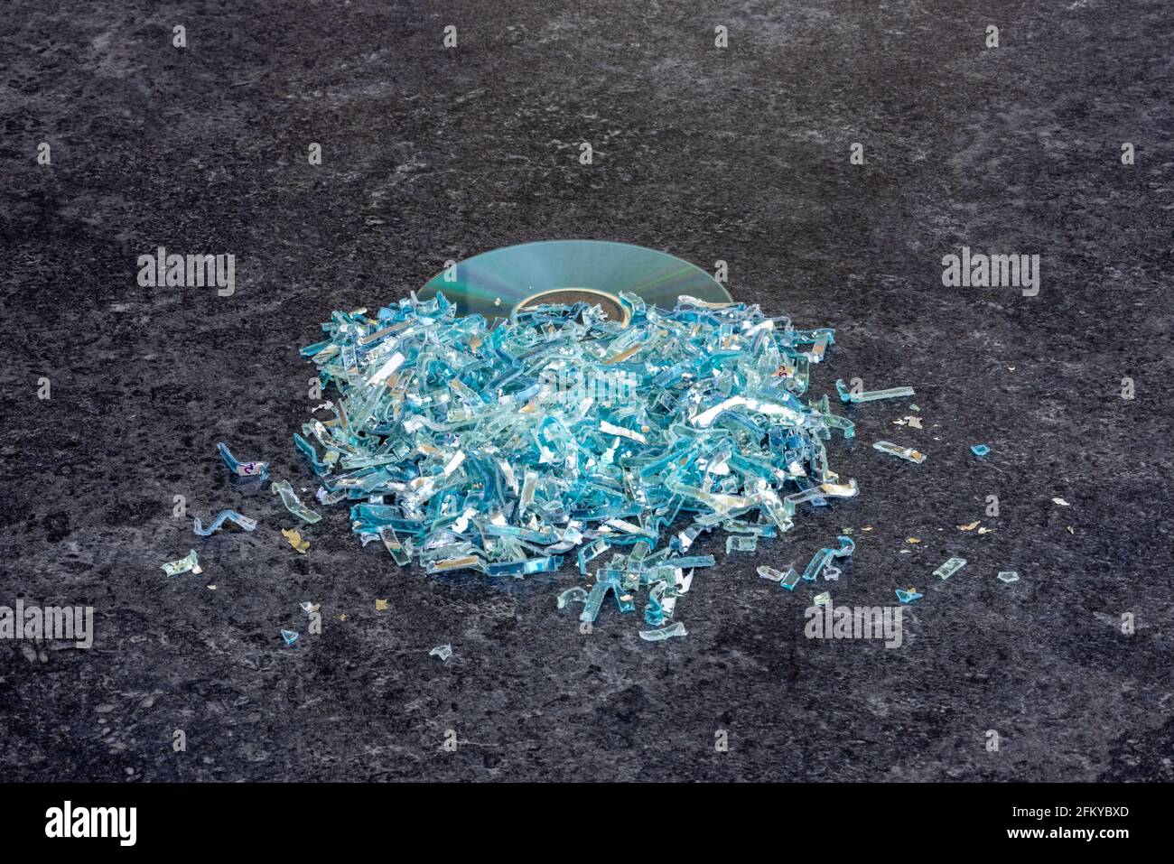blue shimmering shredded parts of a DVD on dark background Stock Photo ...