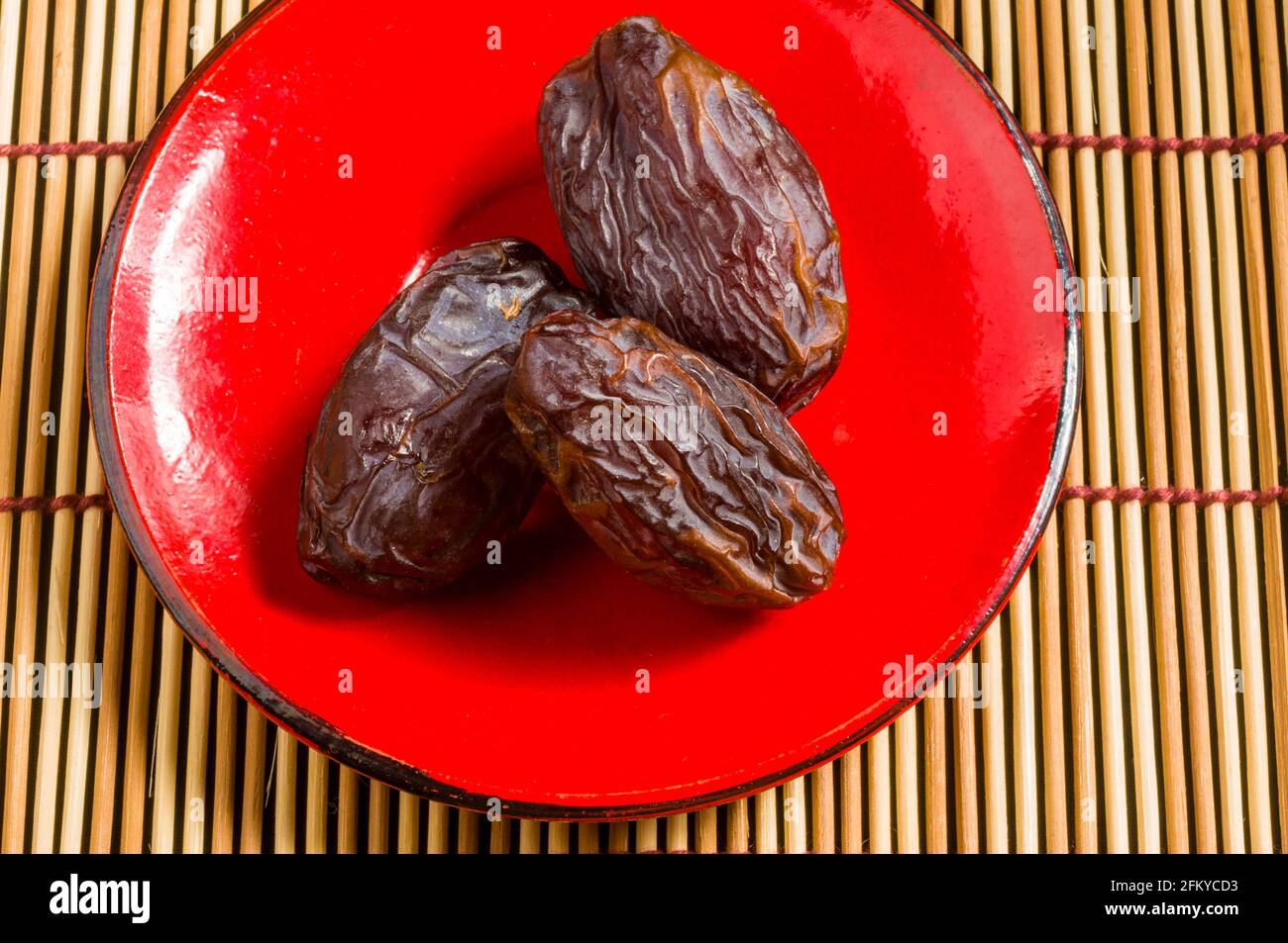 Big luxury dried date fruit in bowls on the bamboo mat, kurma ramadan ...