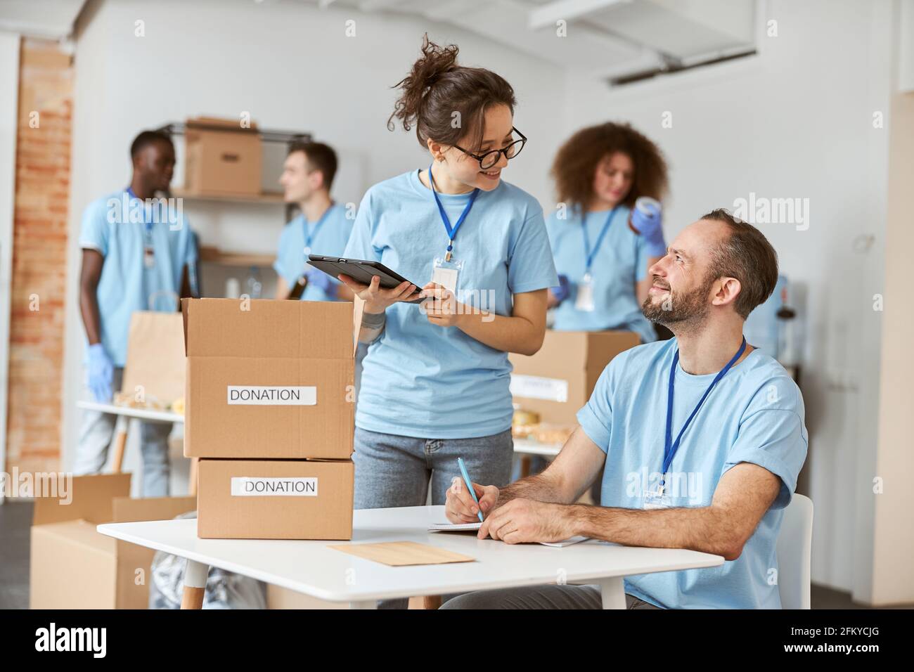 Man giving donation boxes hi-res stock photography and images - Alamy