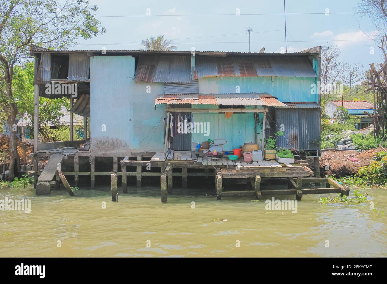 Traditional Vietnamese riverside stilt house along the Hau (Bassac ...