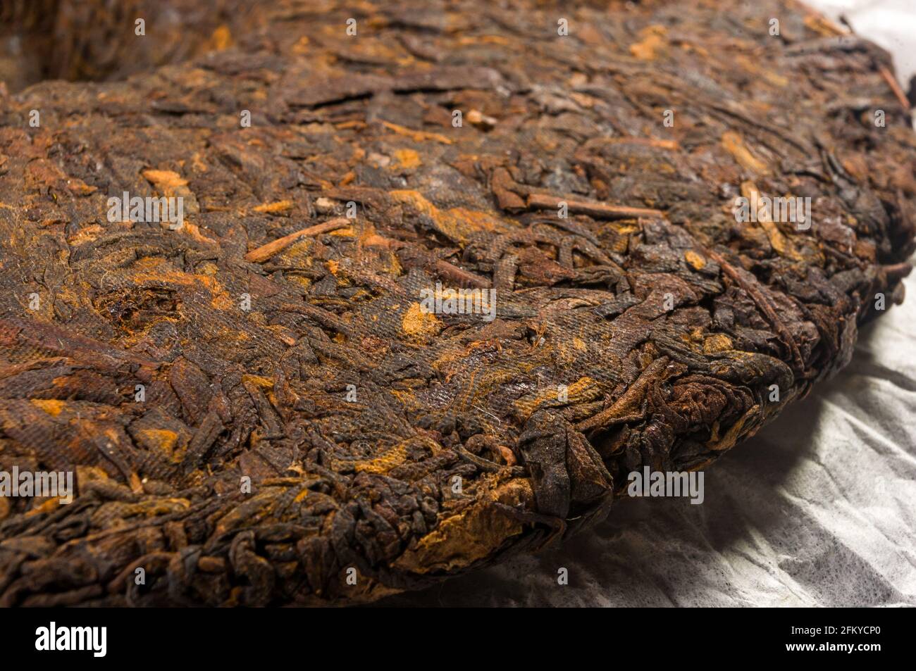 Chinese pressed PU-erh tea on wrapping paper, close-up Stock Photo - Alamy