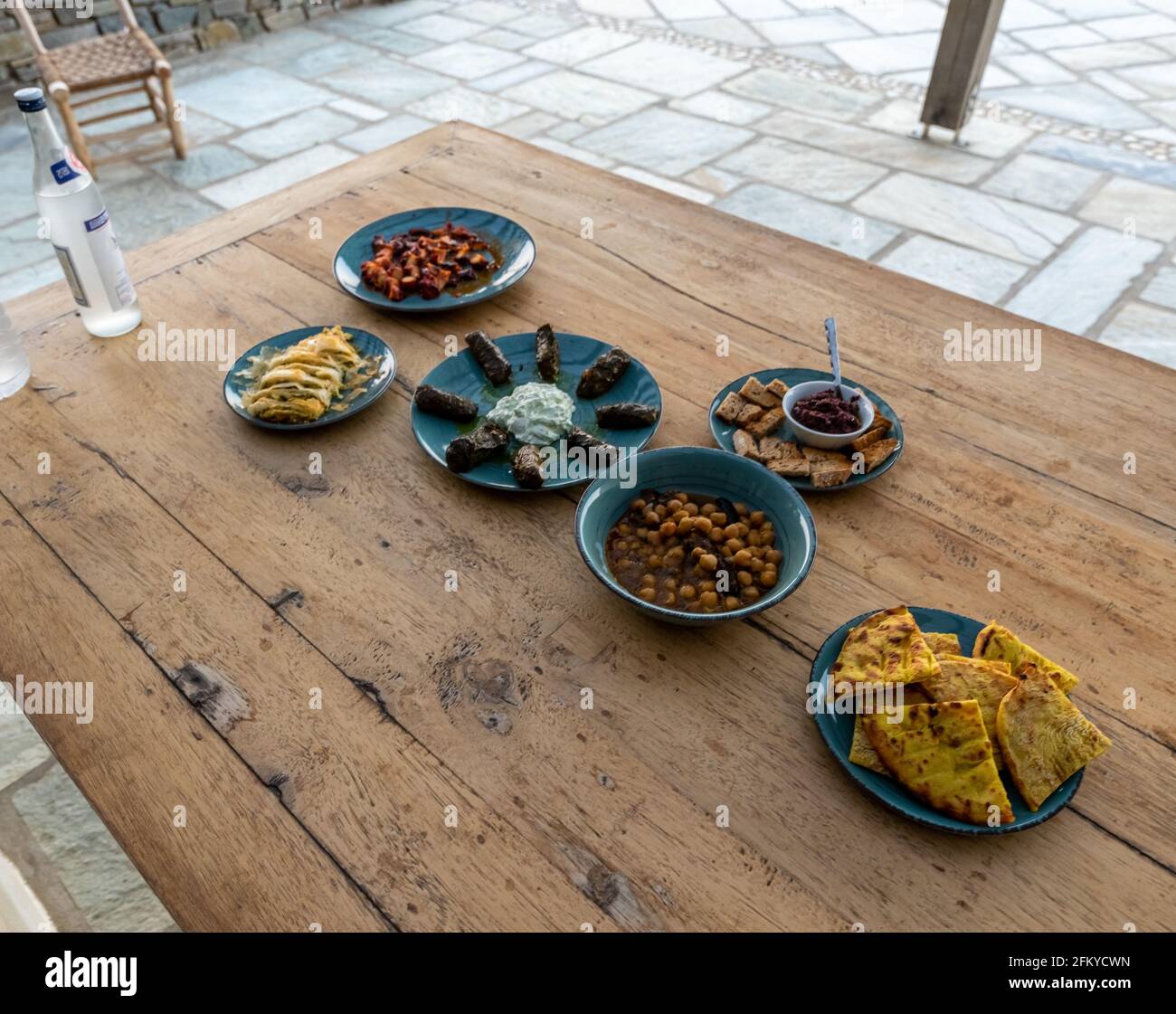 Greek food. pita, tzatziki, stuffed vine leaf, chickpeas salad and ...