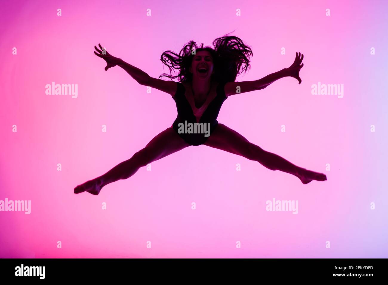 Professional ballerina dancing ballet in a smoke. Female in black ...