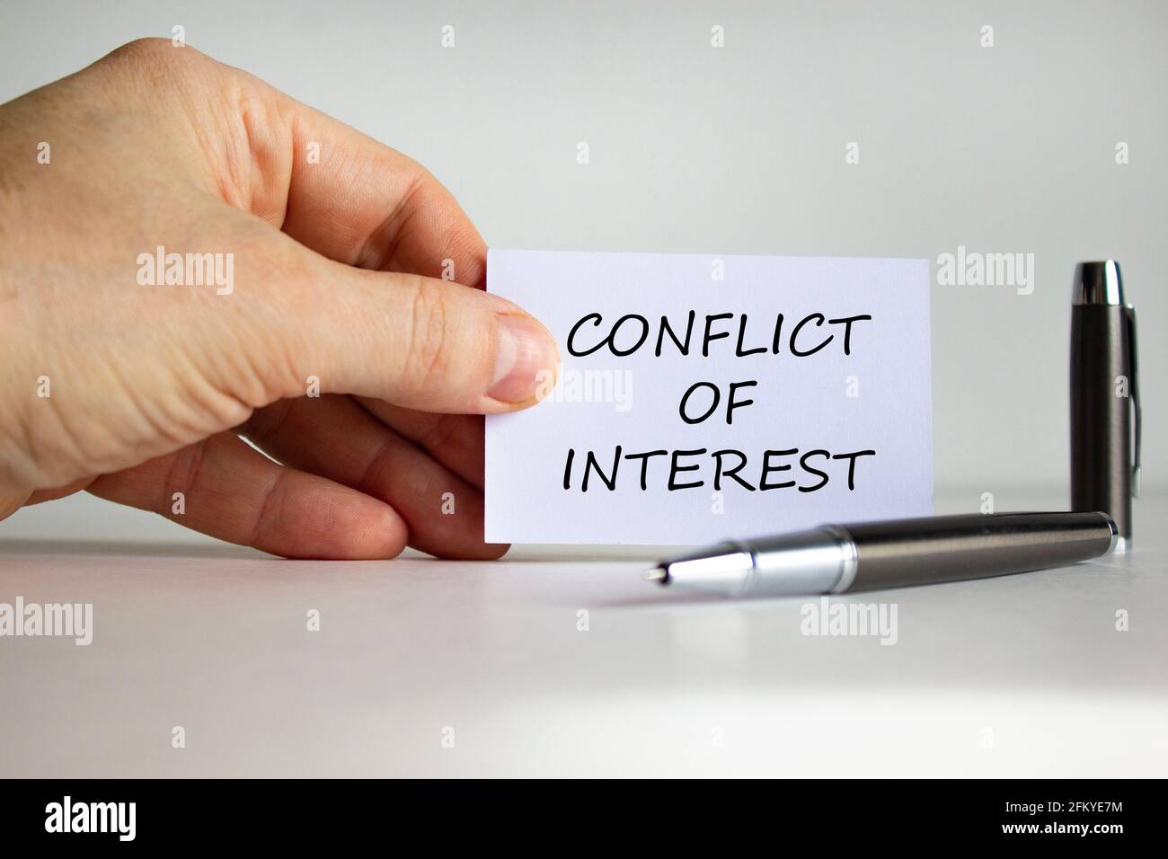 Conflict of interest symbol. White paper with words 'Conflict of ...