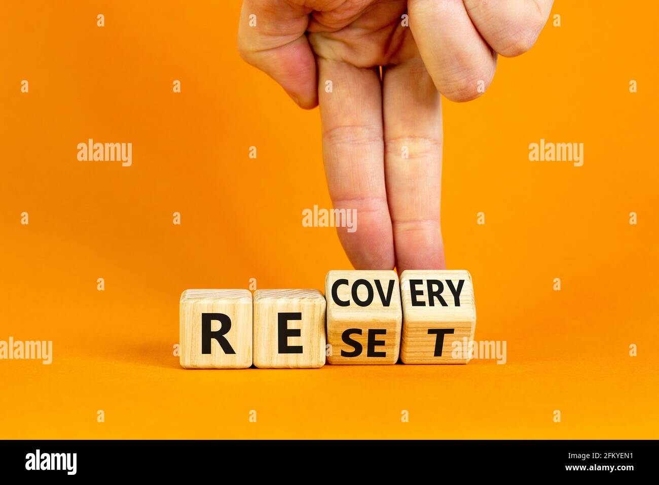 Recovery and reset symbol. Businessman turns cubes and changes the word ...