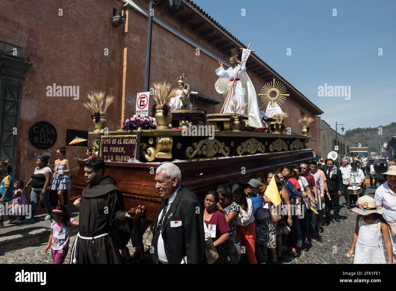 Women carry an elaborate wooden float (anda) during the Semana Santa ...
