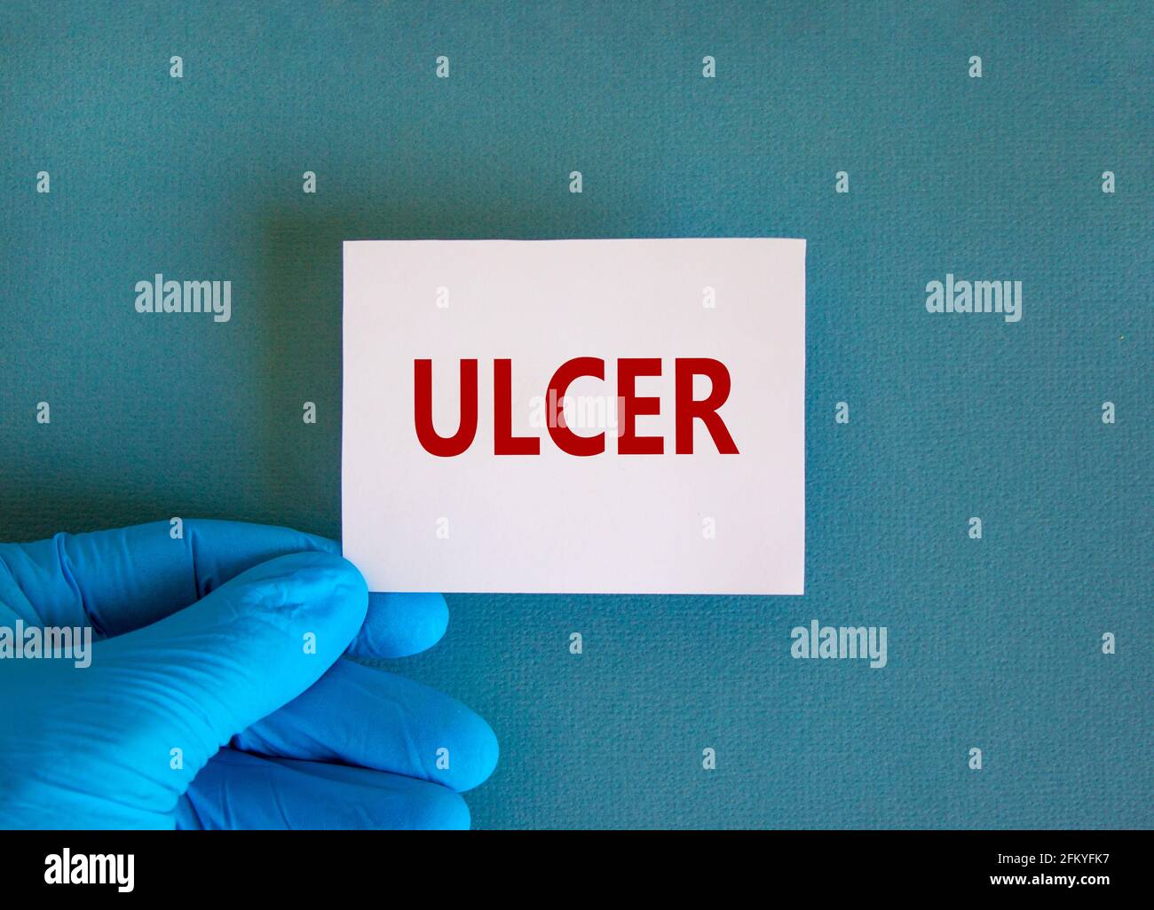 Medical and stomach ulcer symbol. Doctor hand. White card with the word ...