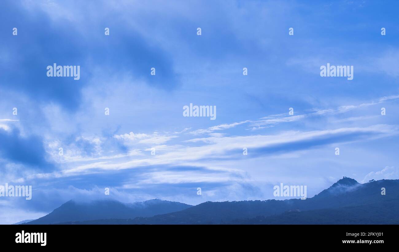 mountains with mist and big blue cloud sky Stock Photo - Alamy