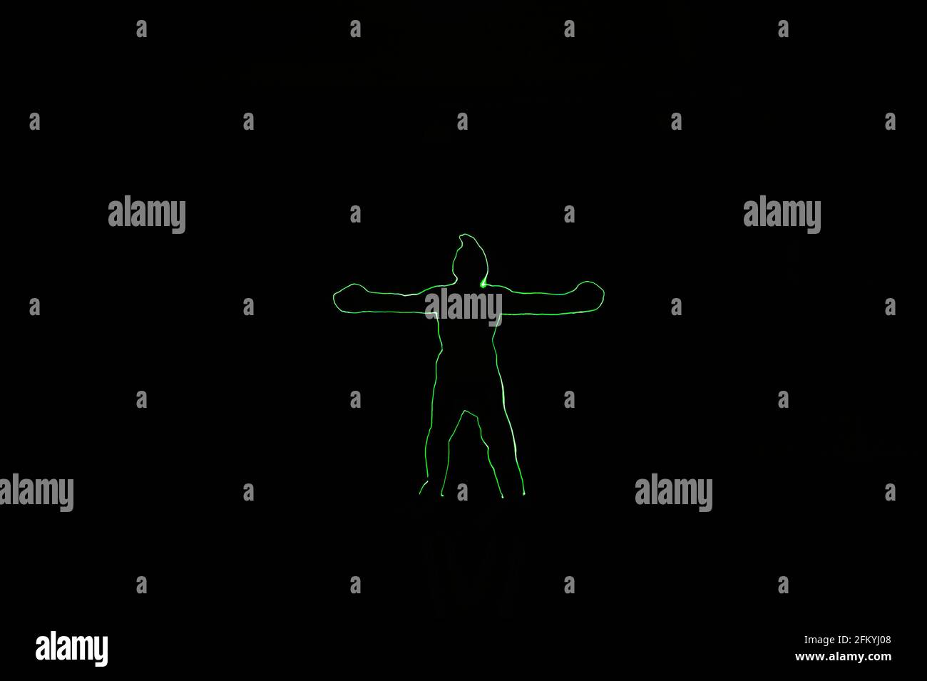 a green light man silhouette on black background Stock Photo - Alamy