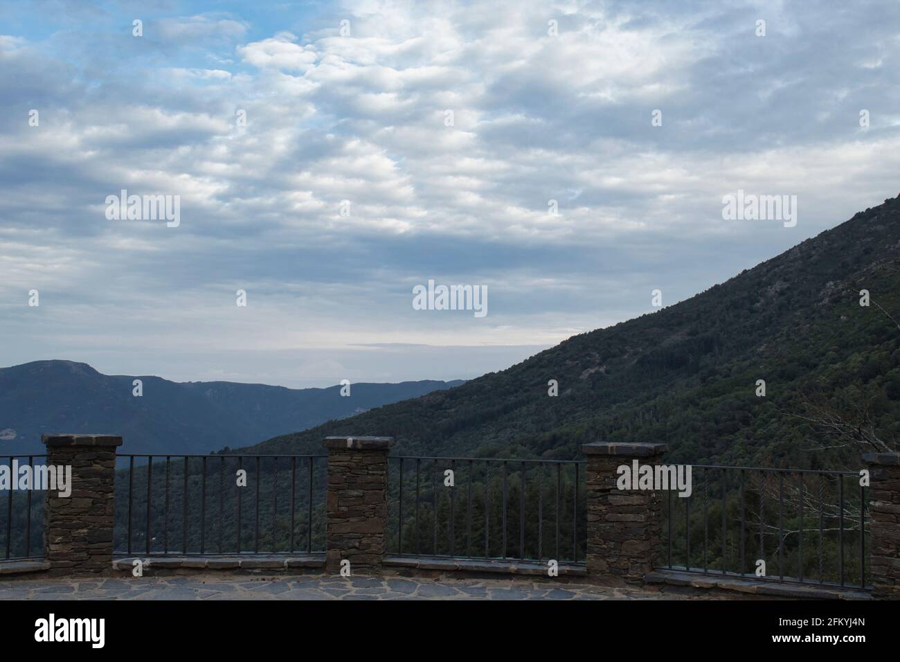 views of a cloudy sky from a stone vantage point in height Stock Photo ...