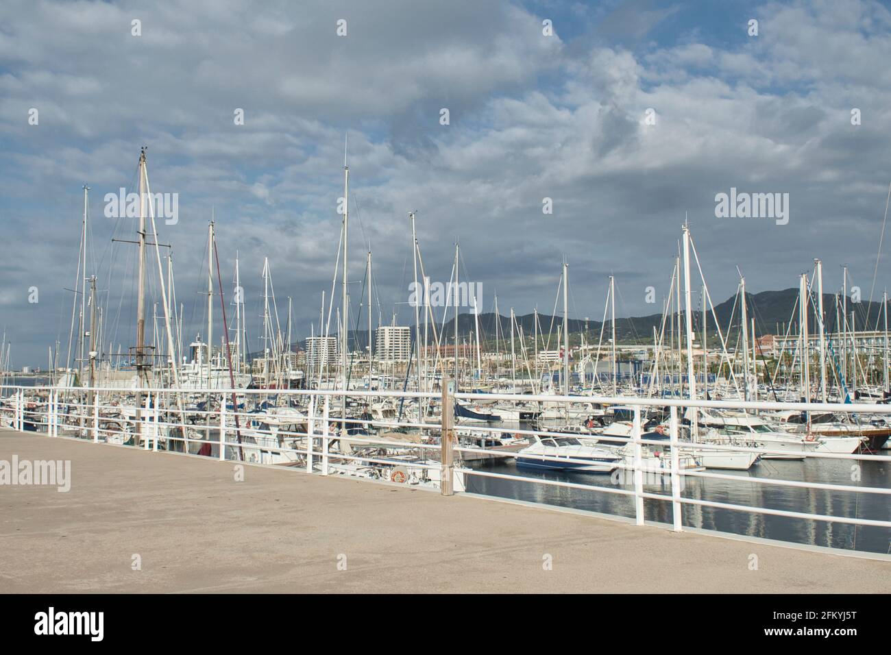 yacht and boats recreational port walkway with clouds and mountains in ...