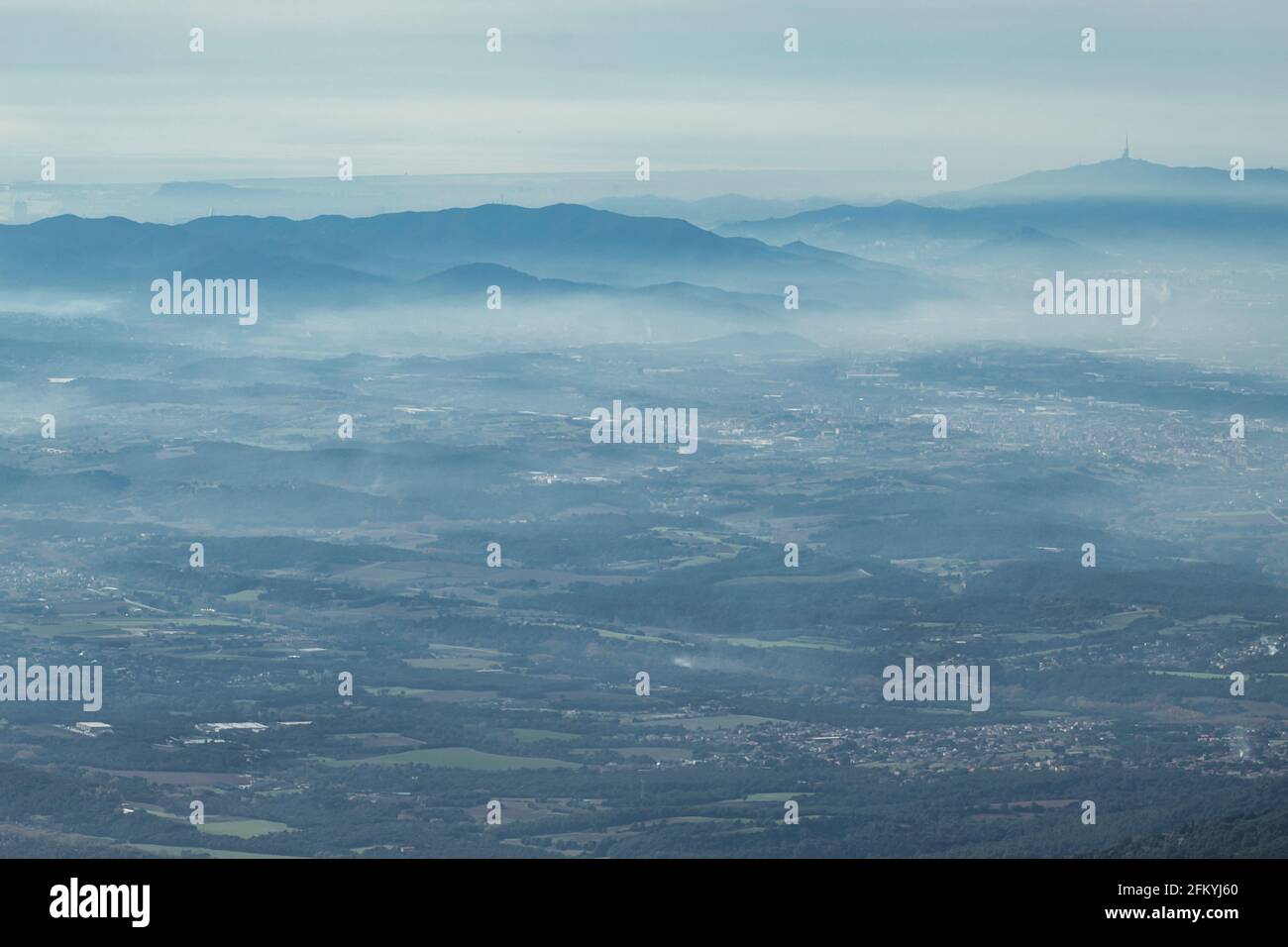 bird-eye view of a valley with mist covering the villages Stock Photo ...