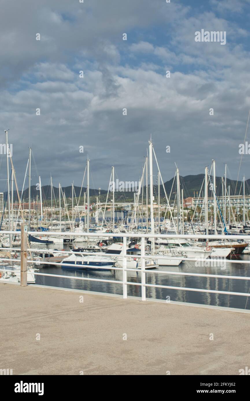 yacht and boats recreational port walkway with clouds and mountains in ...