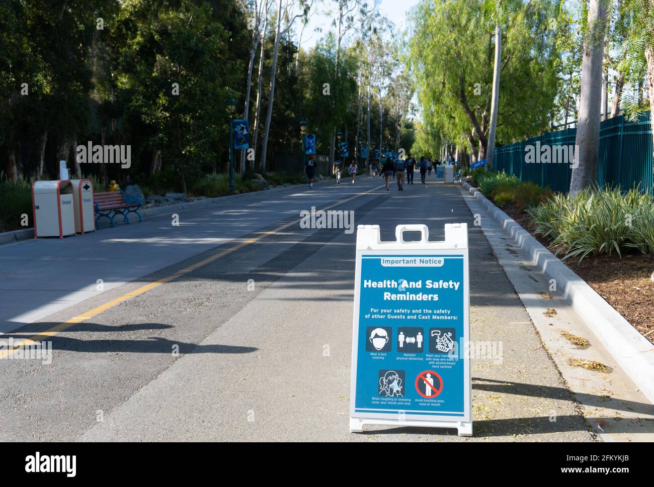 Guests entering Disneyland and walking past health and safety signs ...
