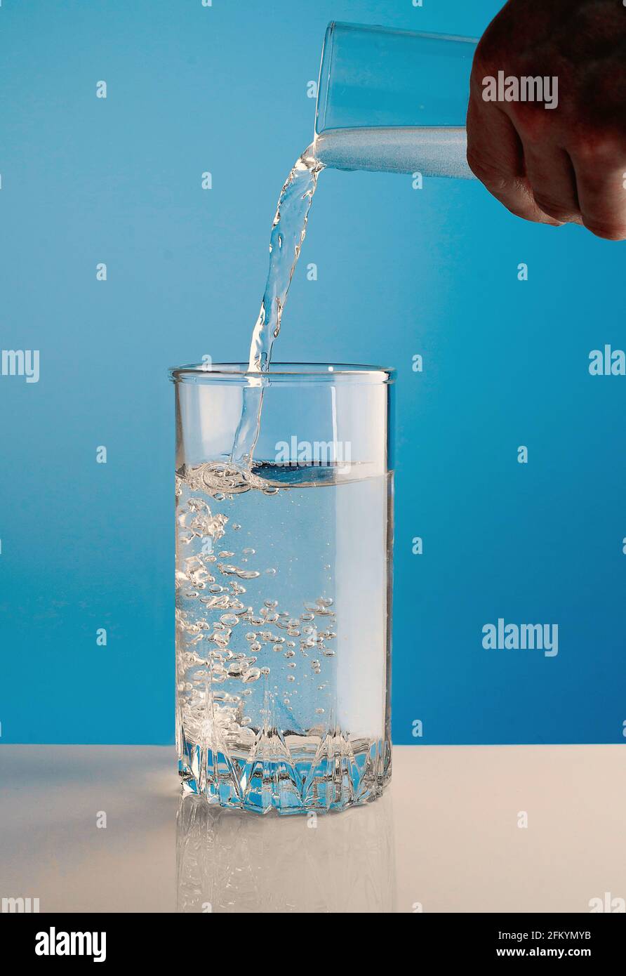 Water pouring into the clear glass Stock Photo - Alamy