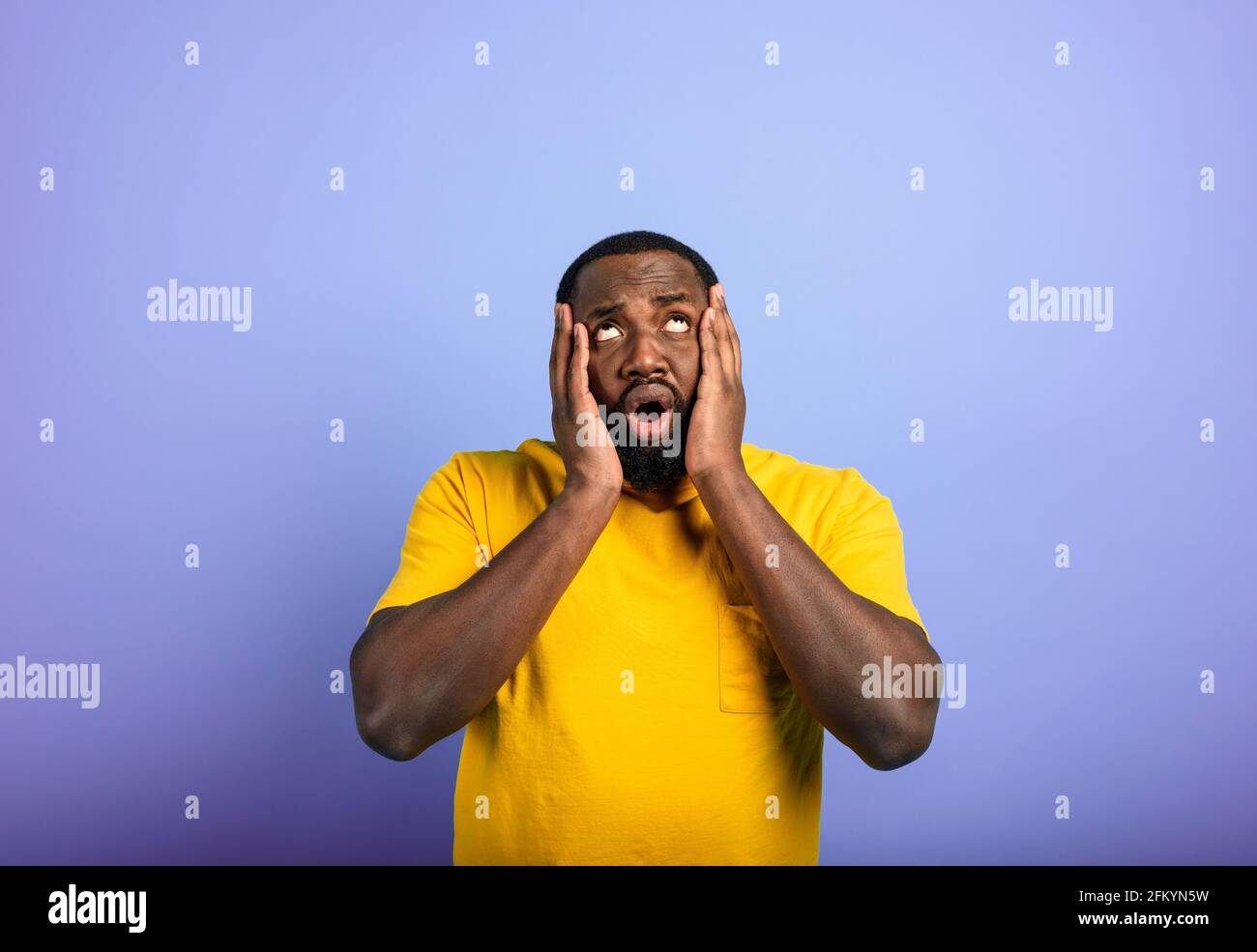 Amazed and shocked expression of a man over purple background Stock ...