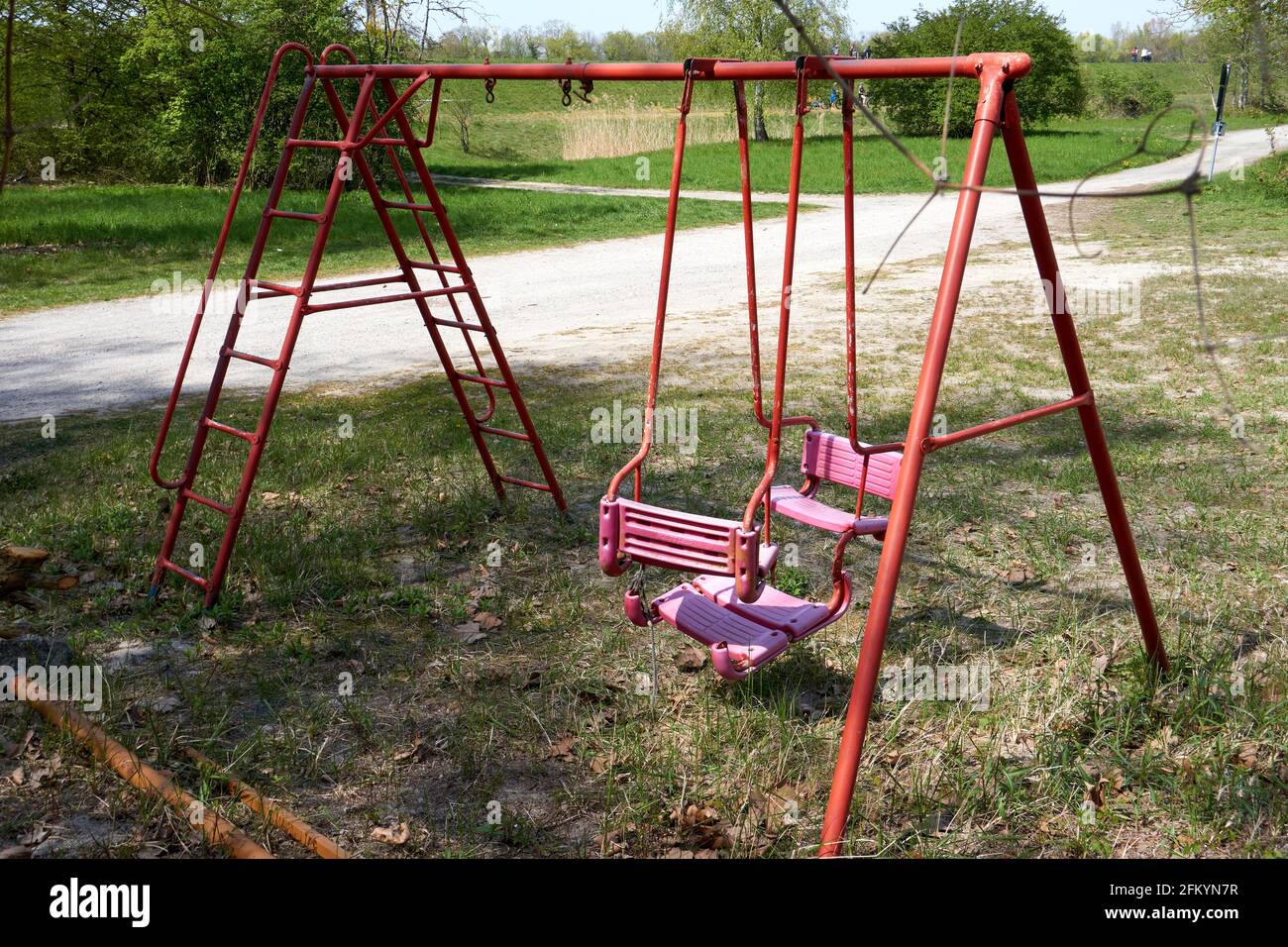 Red swings in a playground Stock Photo - Alamy