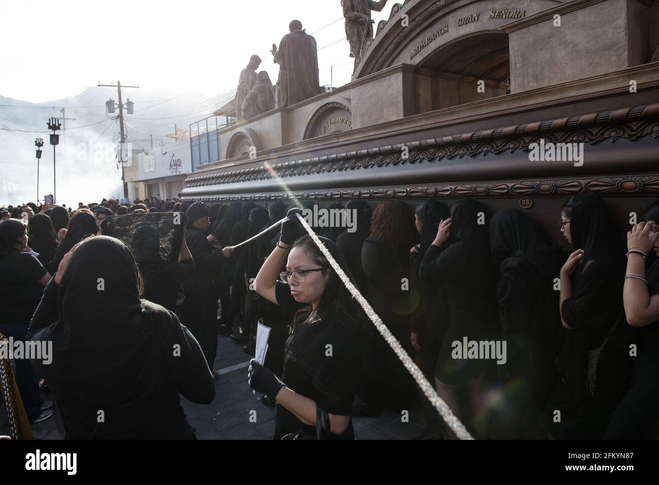 Women carry an elaborate wooden float (anda) during the Semana Santa ...