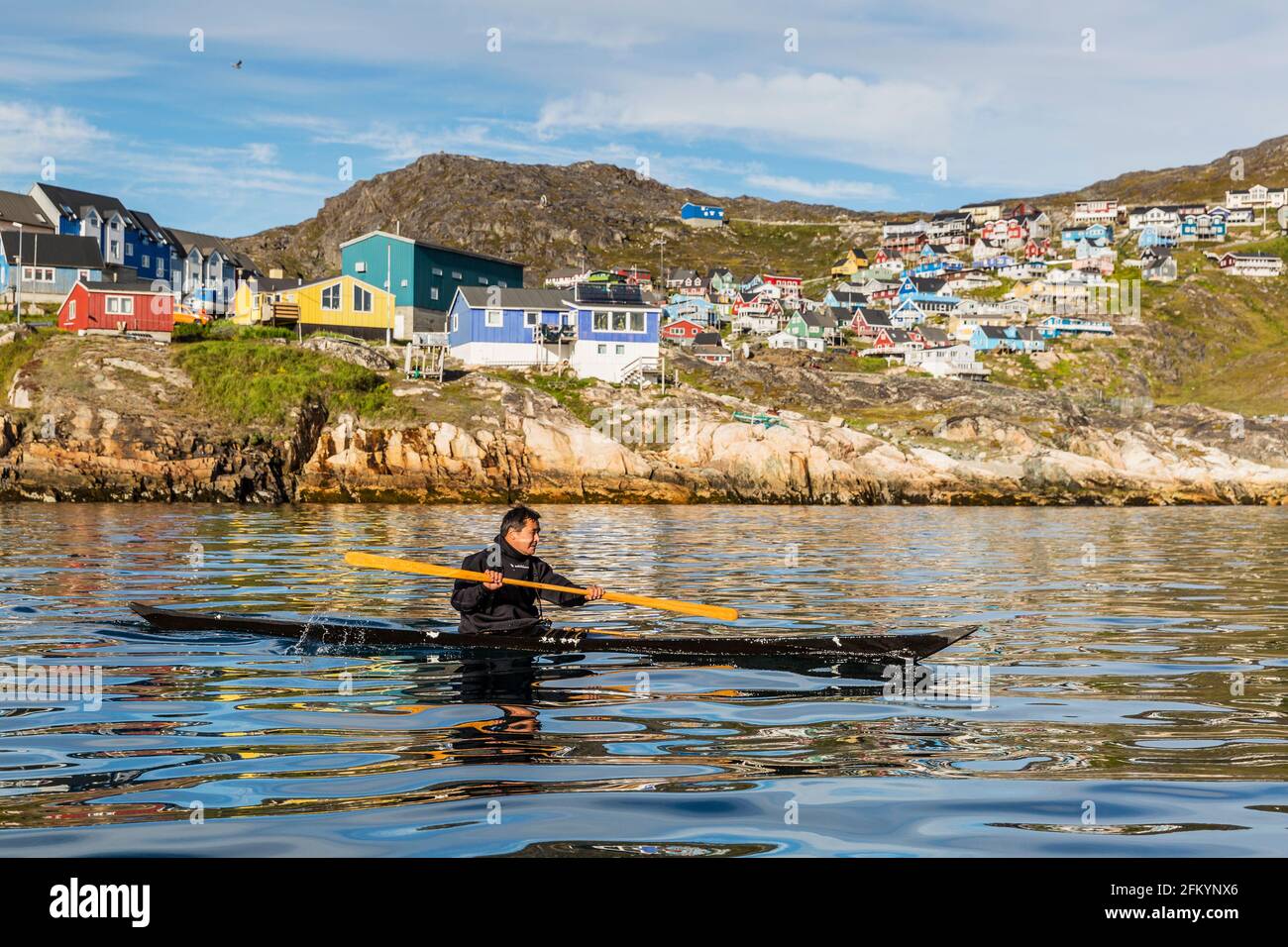Local paddler demonstrates kayak techniques in the Greenlandic town of ...