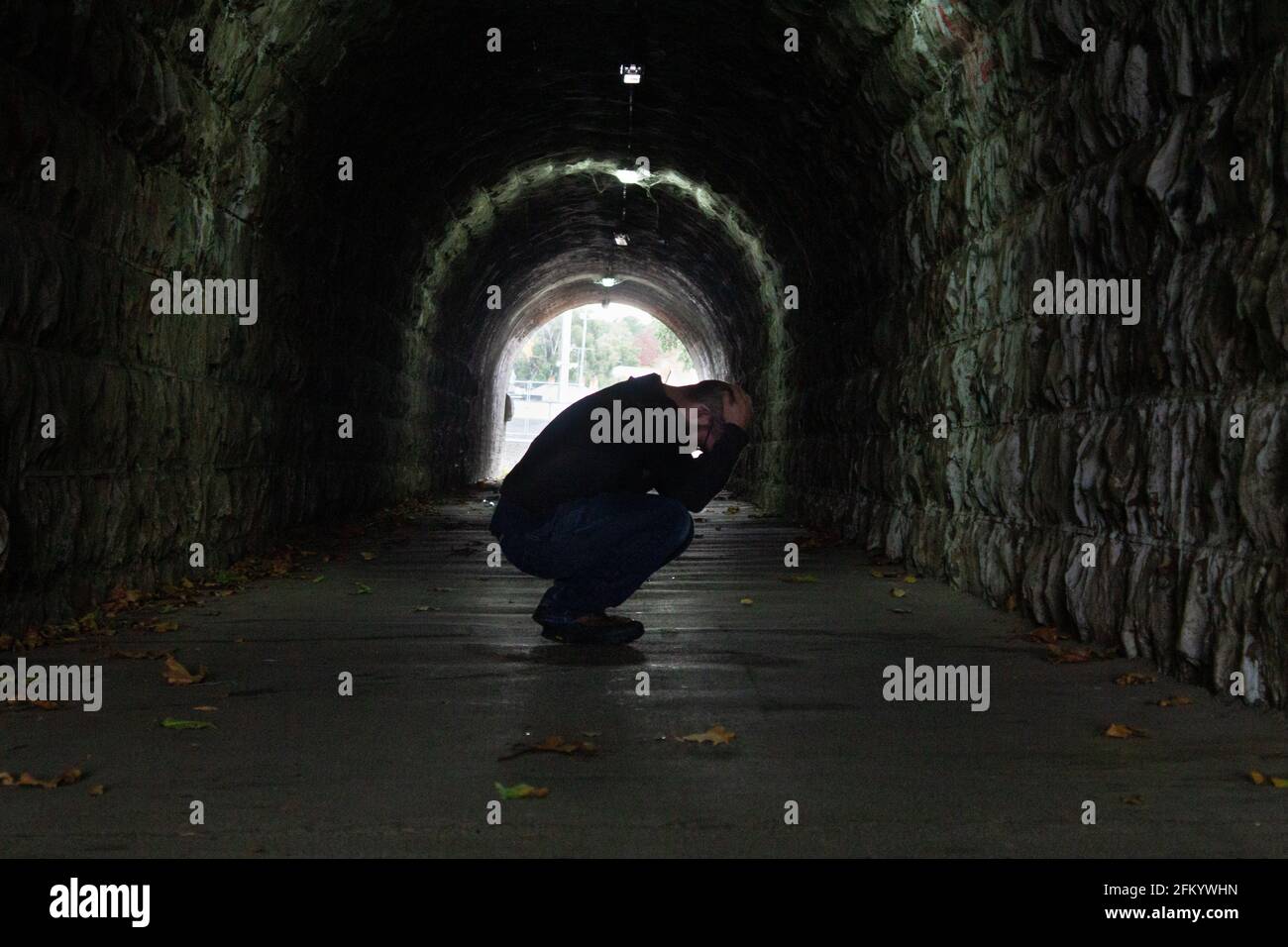 Man crouching scared hi-res stock photography and images - Alamy