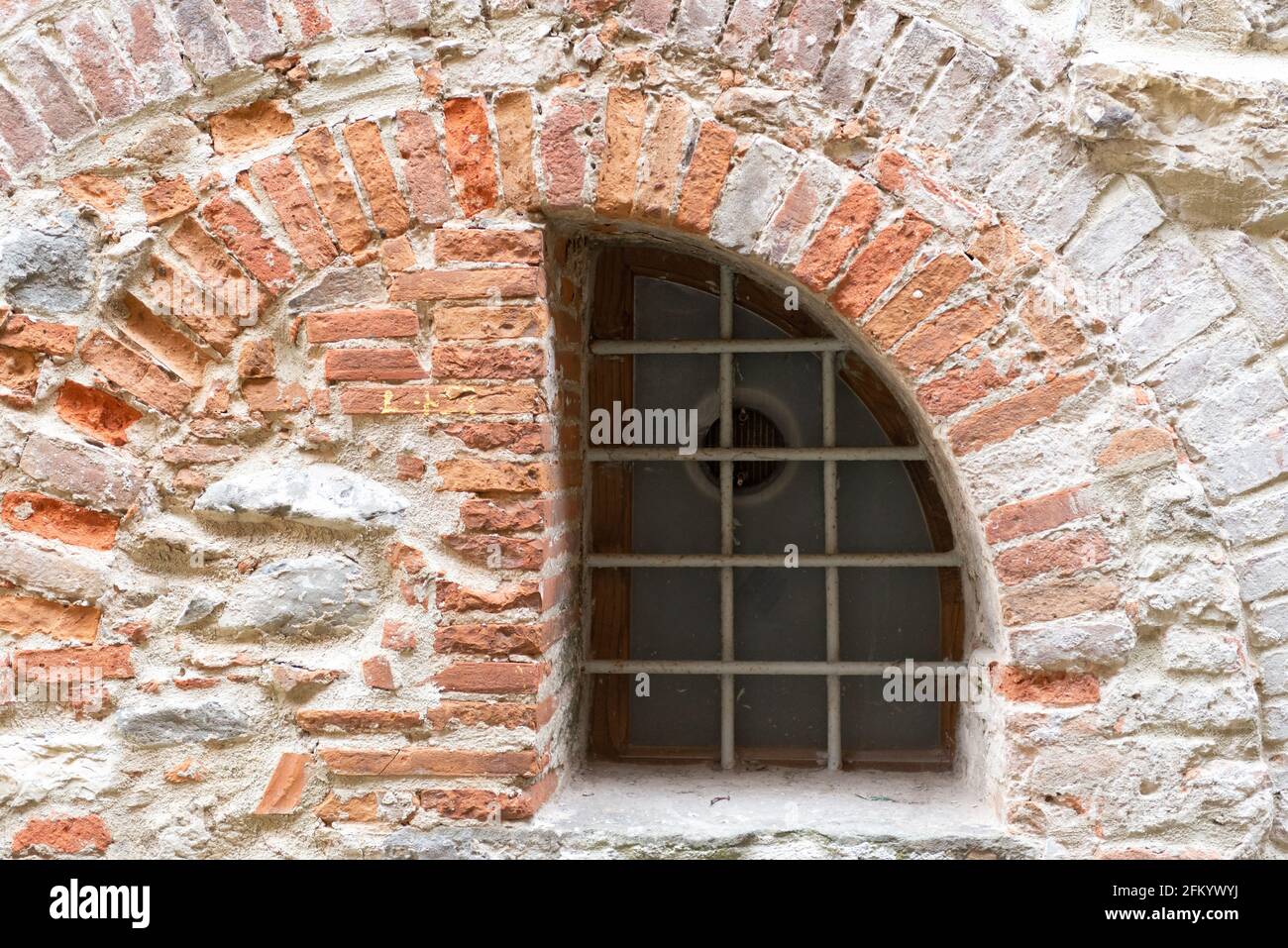 They laid a semicircular window with a brick. A walled-up window that's ...