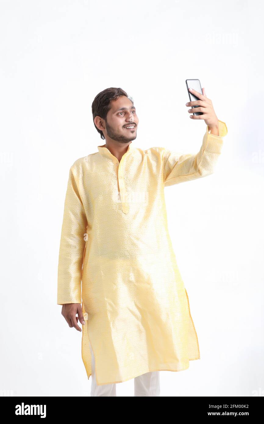 Indian man in traditional wear and taking selfie in smartphone Stock ...