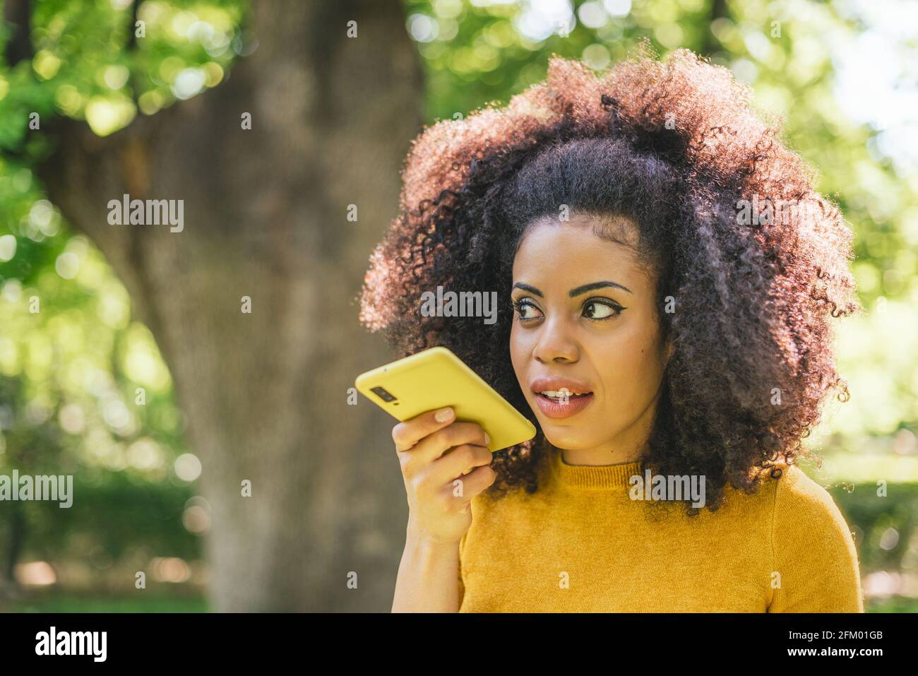 Pretty Afro Woman Sending An Audio Message On Her Mobile Stock Photo Alamy pretty-afro-woman-sending-an-audio-message-on-her-mobile-stock-photo-alamy