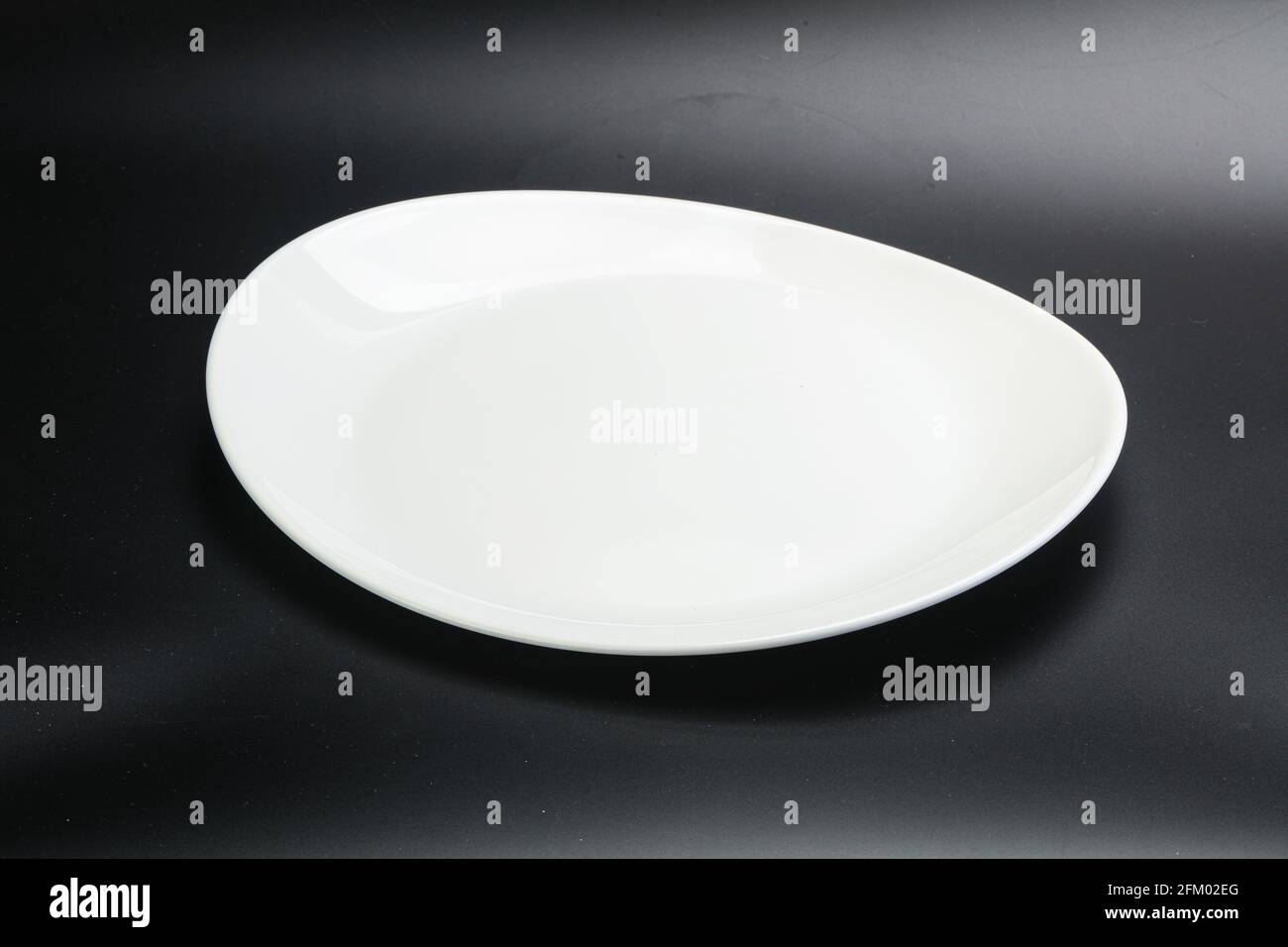 White empty plate for serving isolated Stock Photo - Alamy