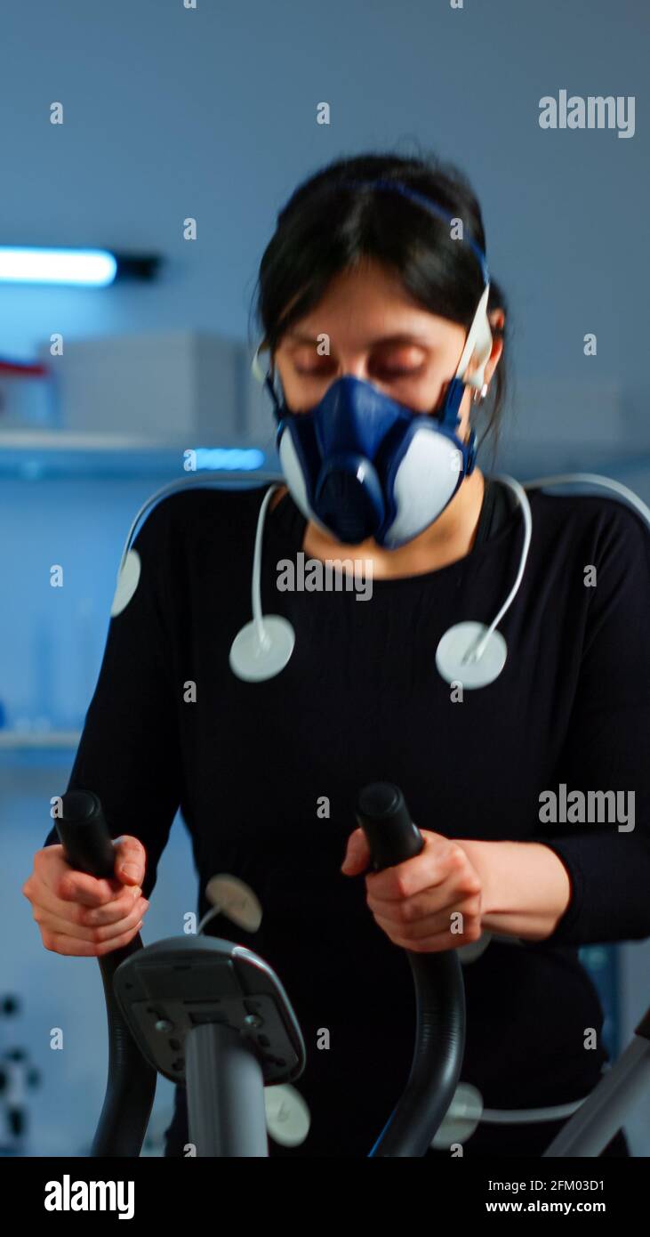 Team of doctor researchers monitoring endurance of woman performance ...