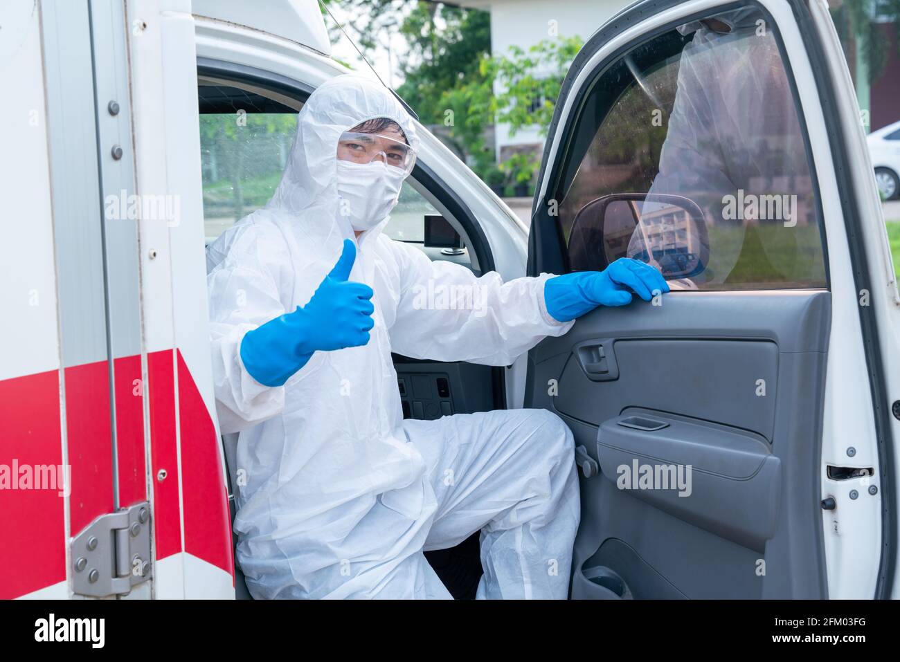 Happy driver wear PPE in front of the ambulance with protective suit ...