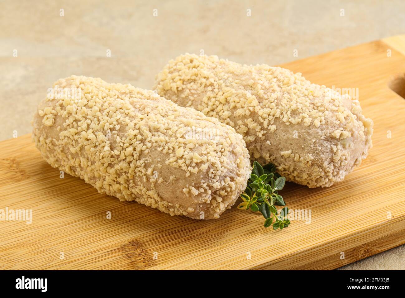 Raw breaded chicken cutlet for roast Stock Photo - Alamy