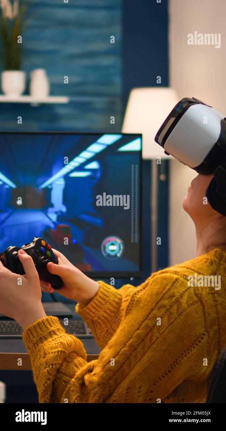 Professional gamer wearing virtual reality headset using wireless ...