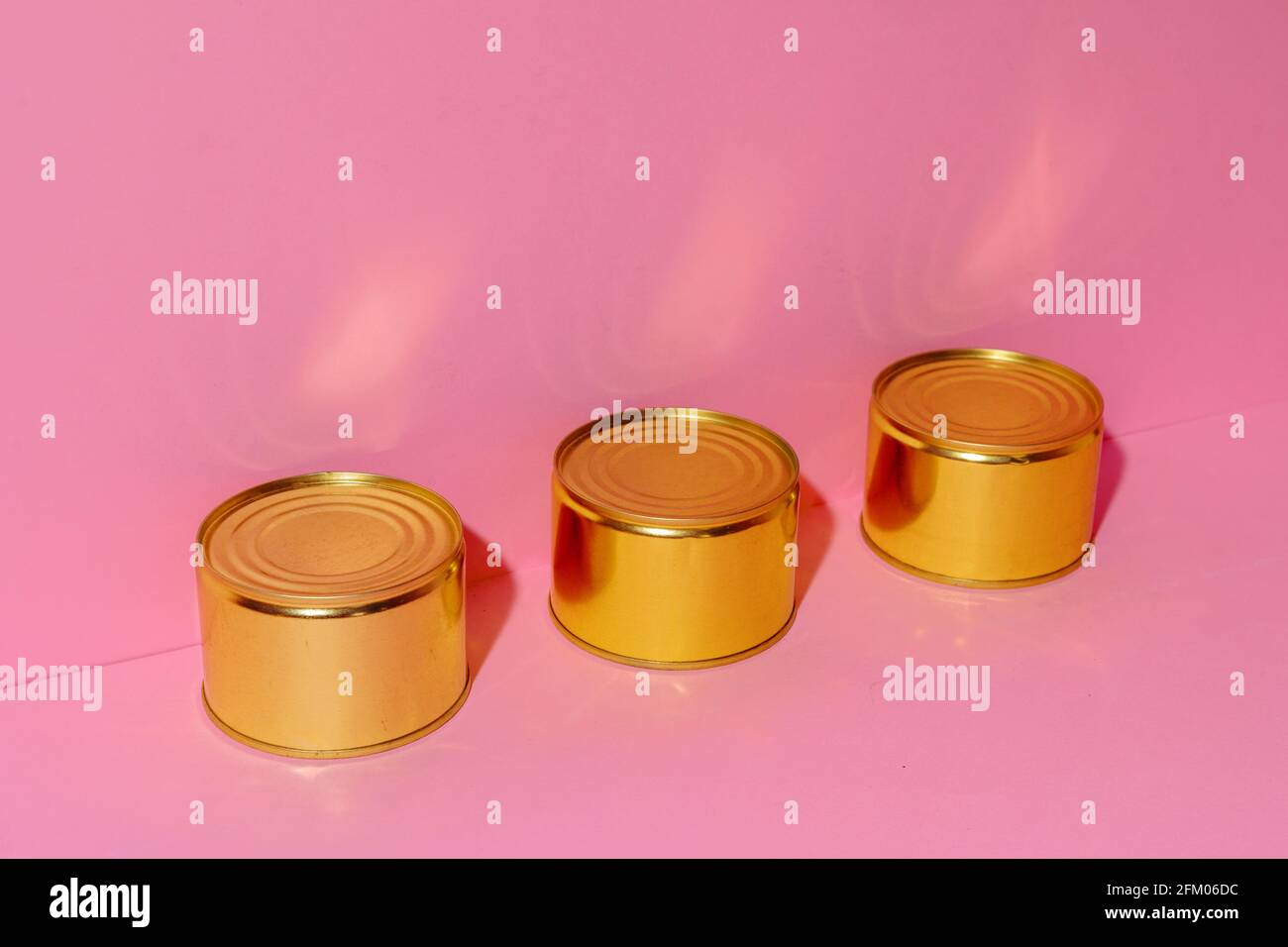 Canned food tin on pink studio background Stock Photo - Alamy