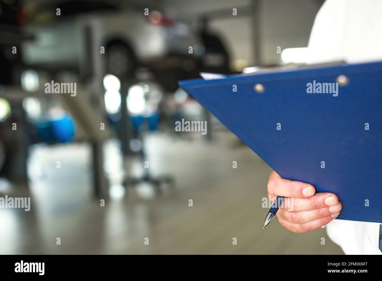 Master receptionist in a car service station with a tablet for ...