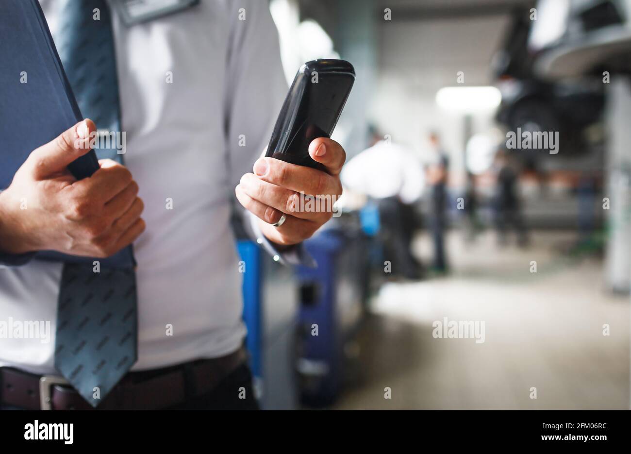 Master receptionist in a car service station with a tablet for ...