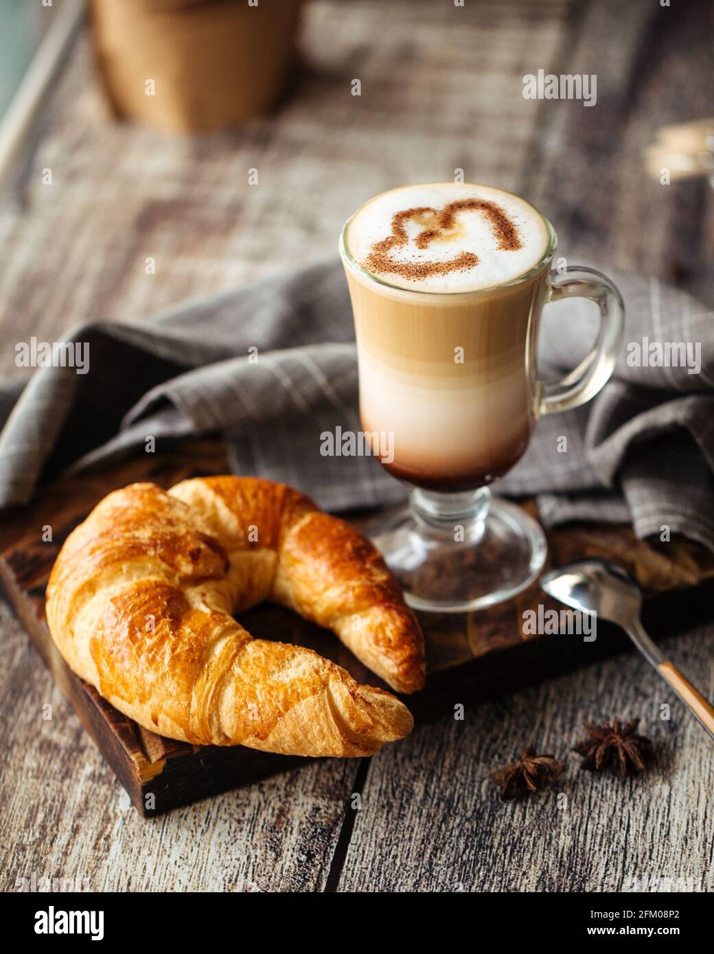 French croissant and mug of coffee latte Stock Photo - Alamy