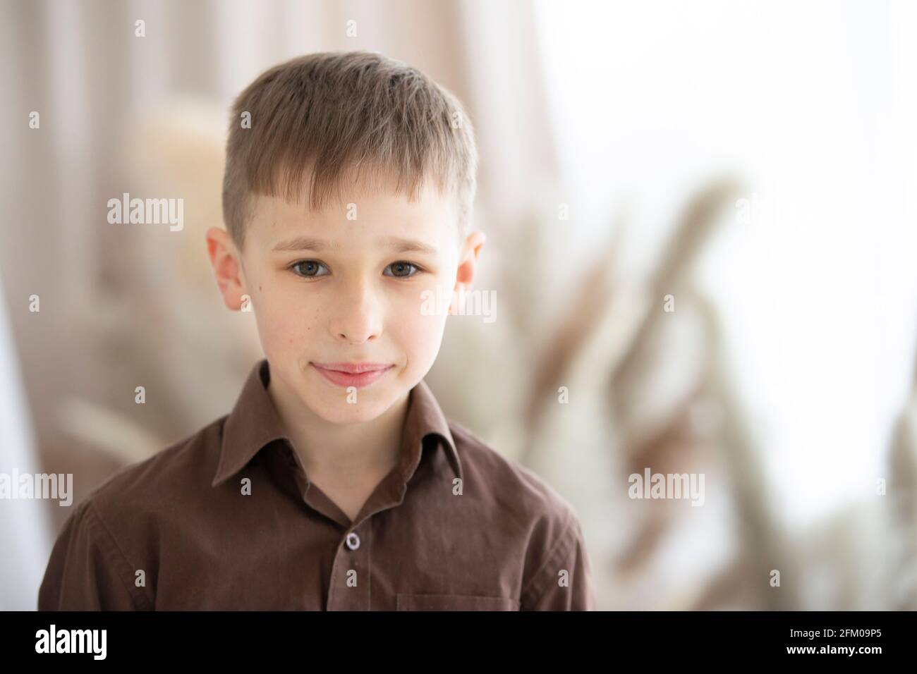 A boy of nine or ten years of European appearance is looking at the ...
