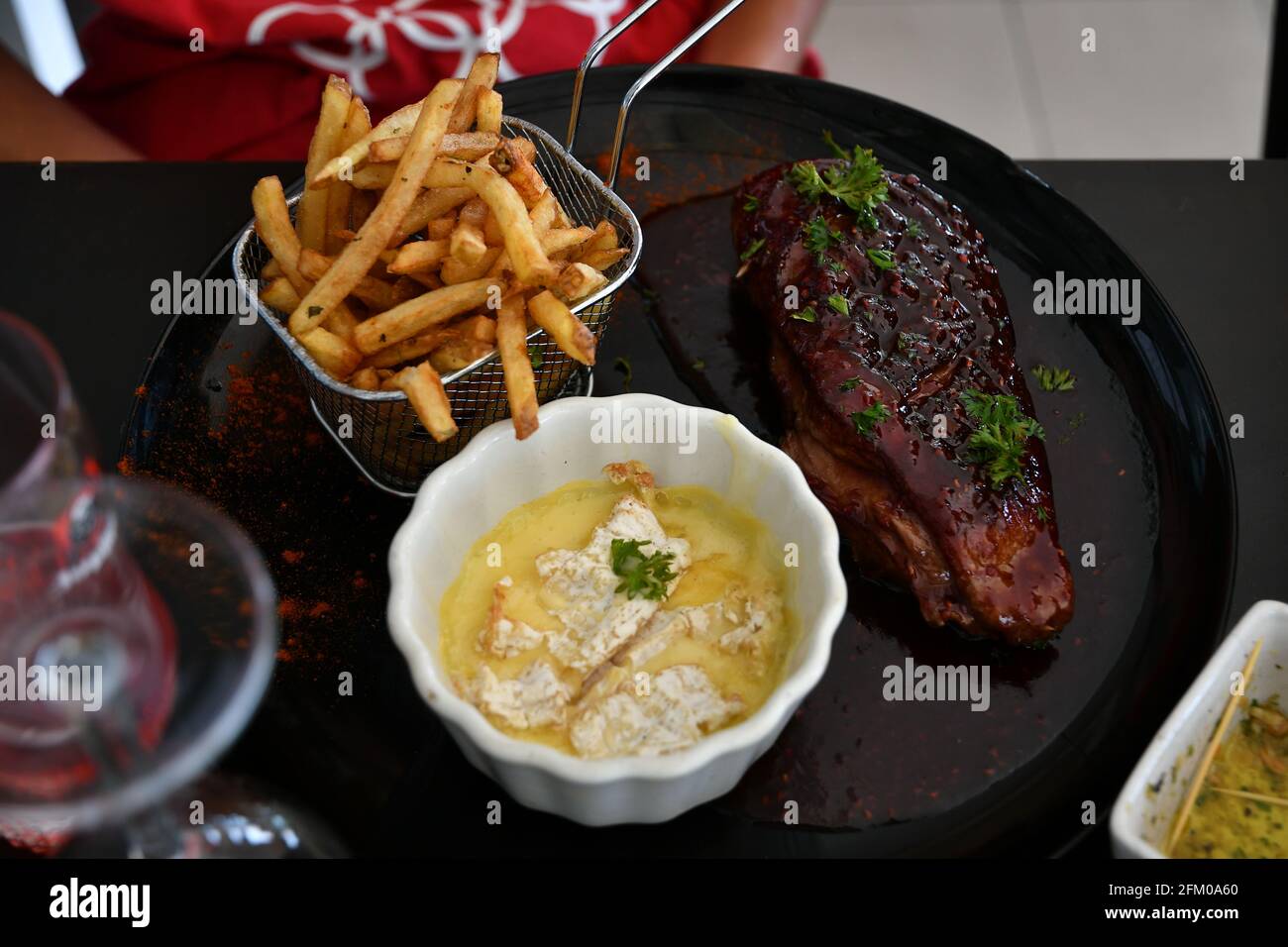 BBQ beef and fries with French cheese on a restaurant table in the ...
