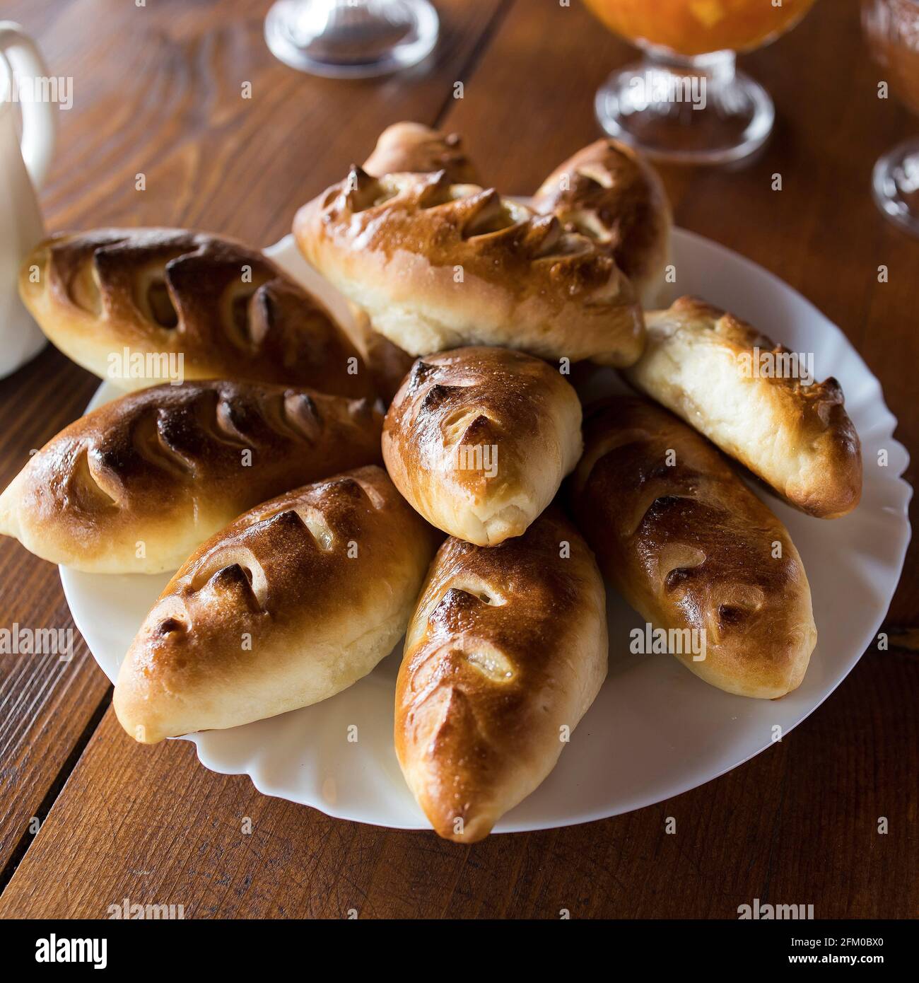 Apple pies on a plate are served with tea and jam. Russian tea time ...
