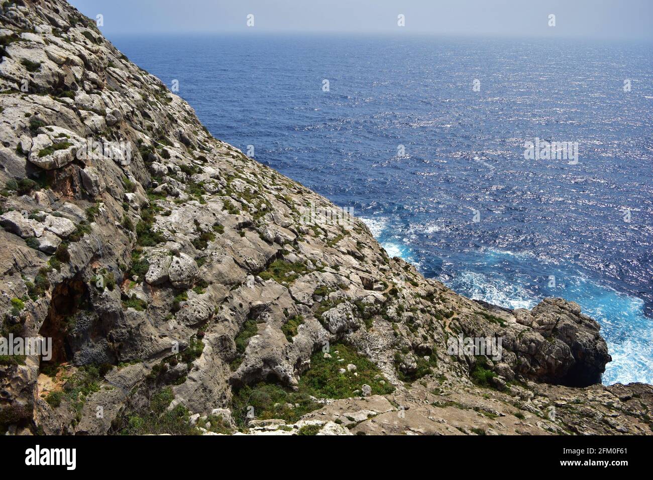 Dry valley and coastal cliffs in southern Malta next to the sea Stock ...
