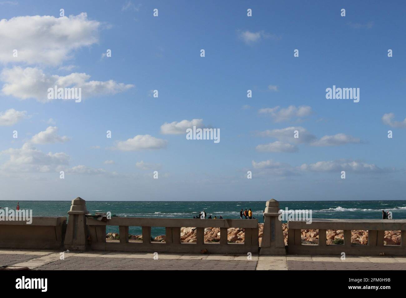 The beach of the sea in Alexandria Egypt with cloudscape , boats and ...