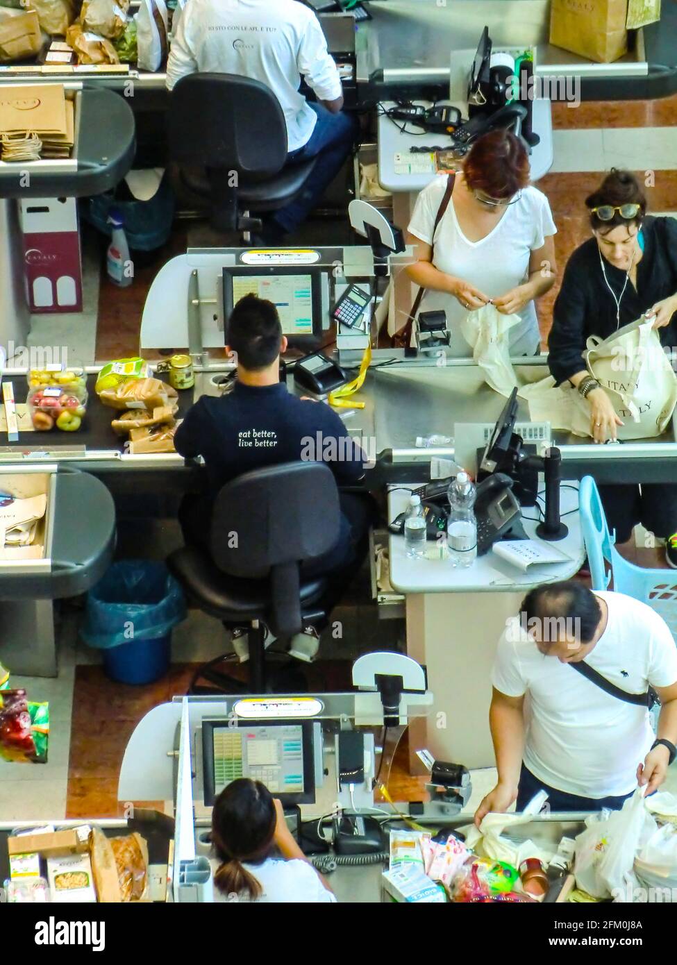 Top view picture of cashier on workspace in Eataly supermarket shop ...