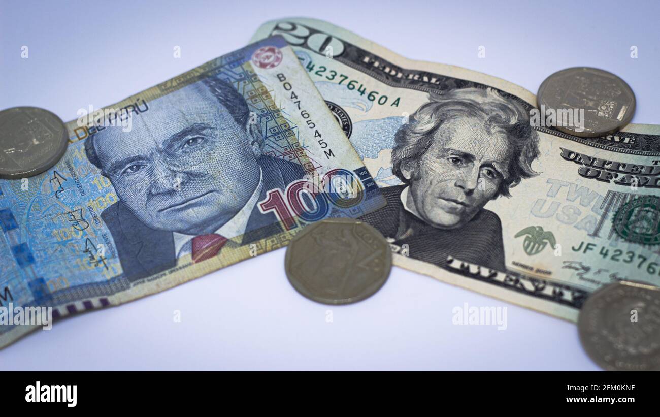 Closeup of Peruvian sol and US dollar bills on white background Stock ...