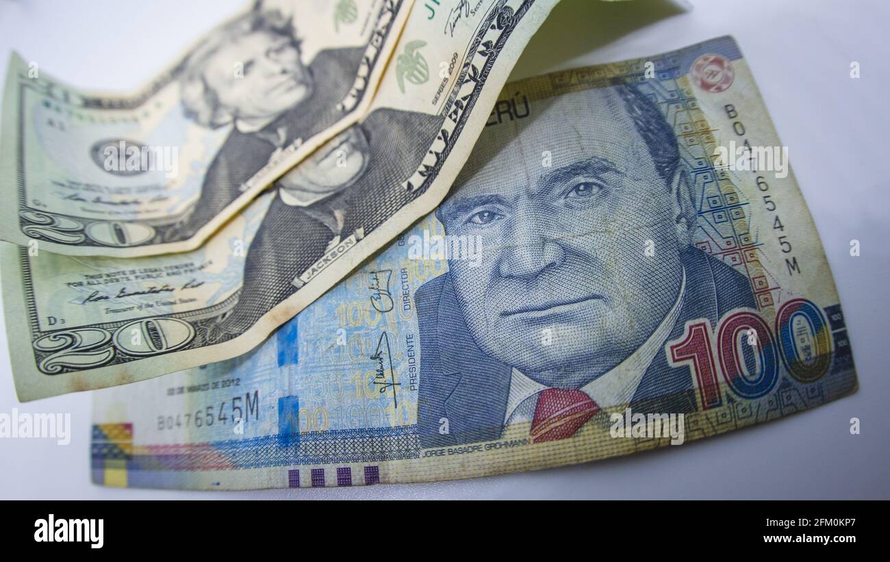 Closeup of Peruvian sol and US dollar bills on white background Stock ...