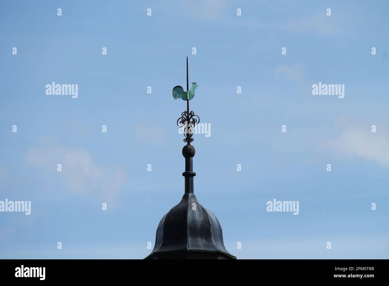A Cockerel Wind Vane on Top of a Building Tower Stock Photo - Alamy