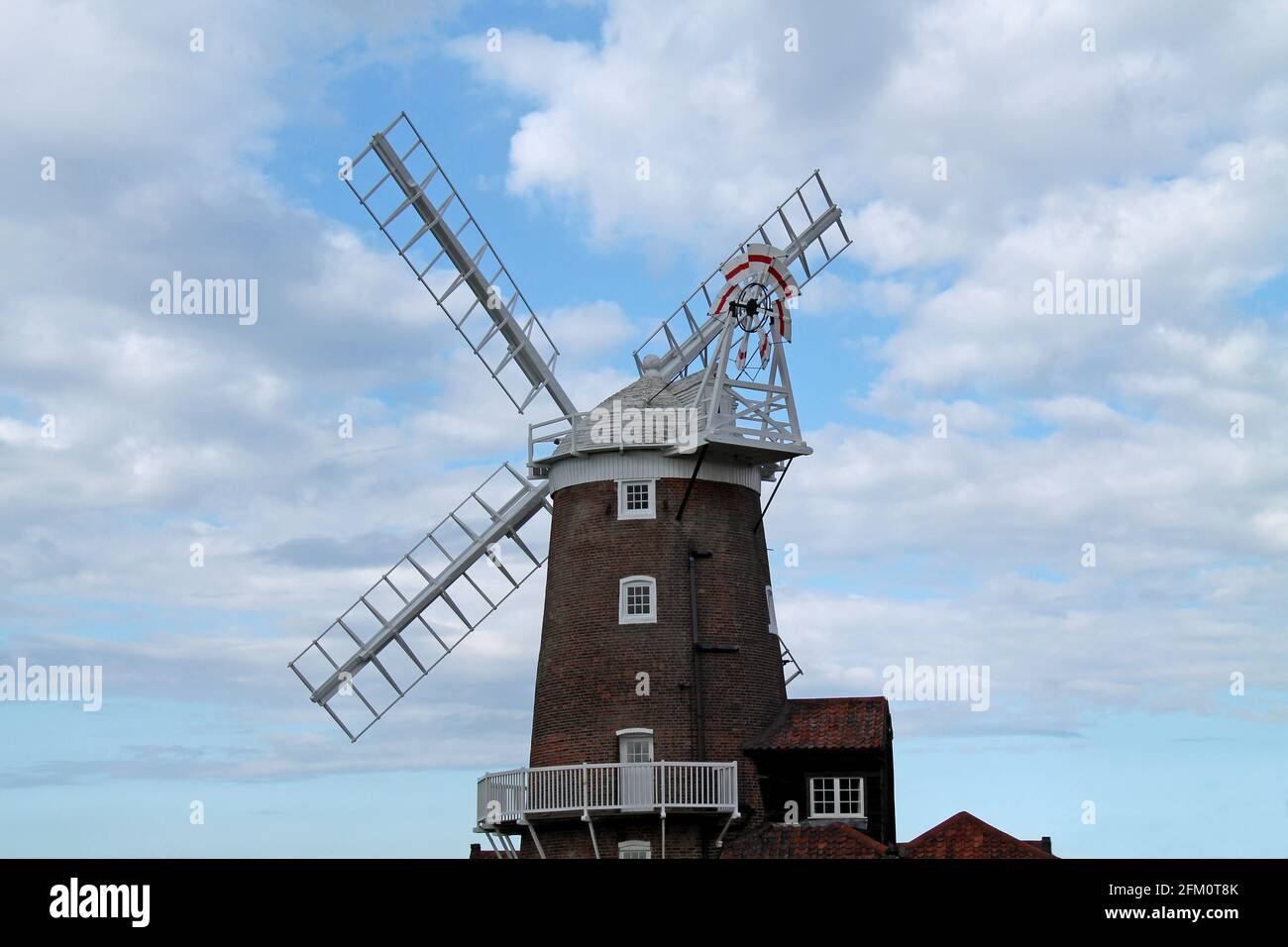 A Brick Built Traditional Windmill with Wooden Sails Stock Photo - Alamy