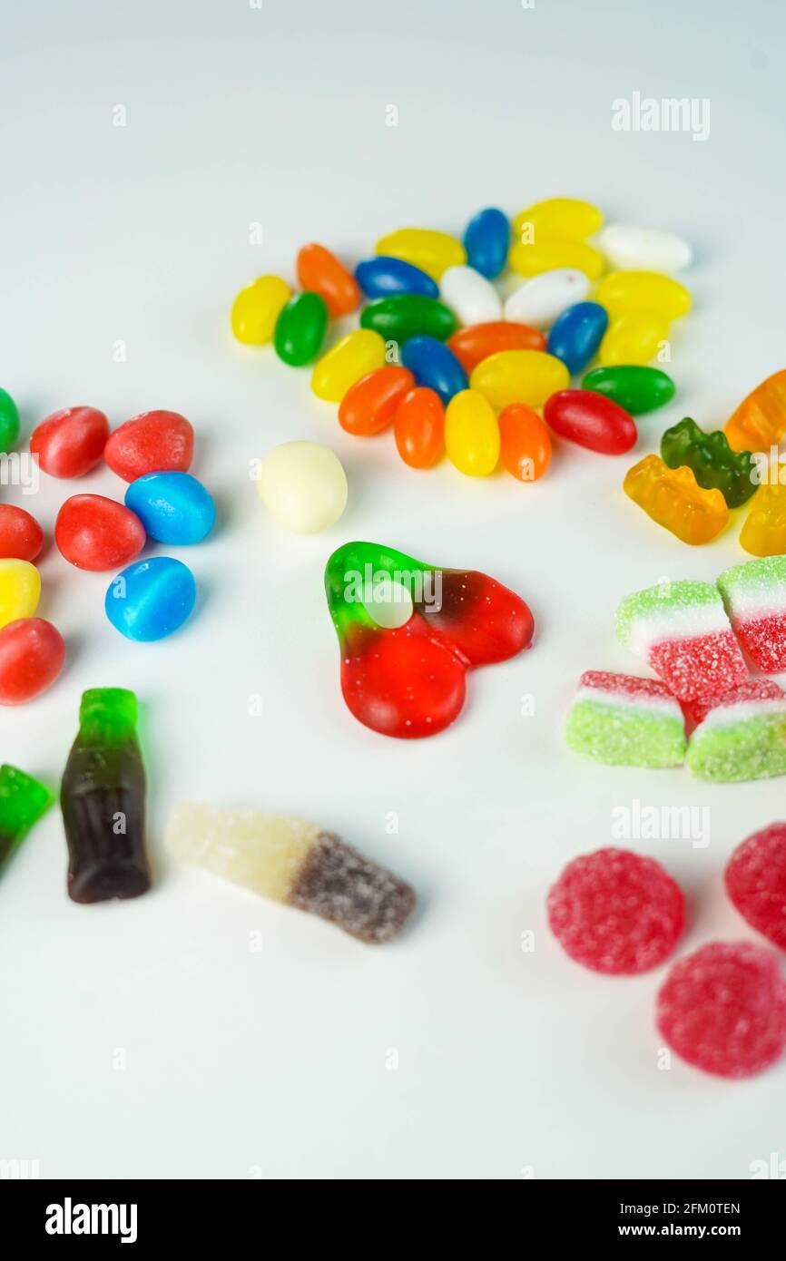Many sweets and candies on a white background. Too much sugar concept ...